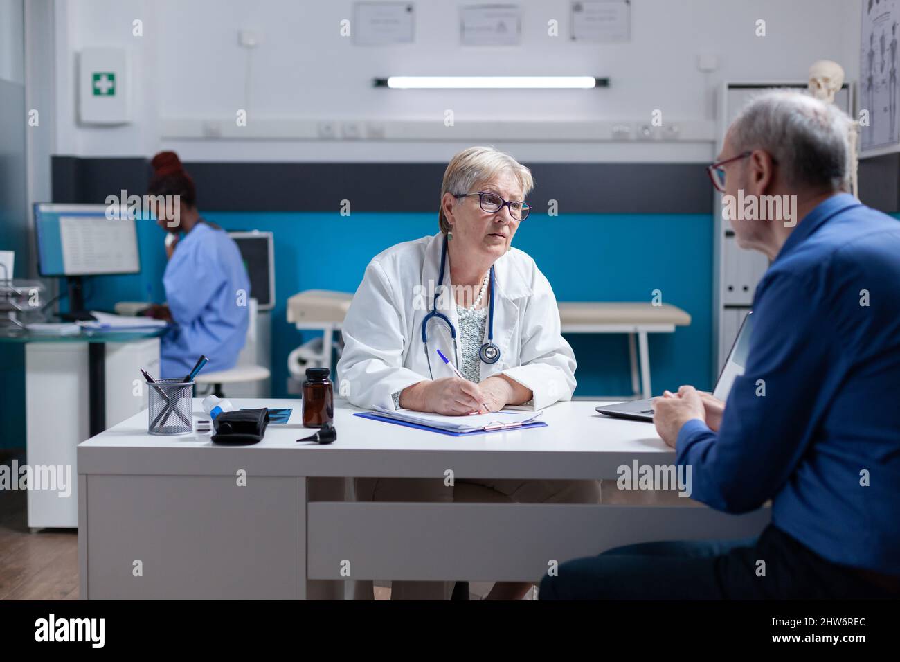 Doctor giving patient documents hi-res stock photography and images - Alamy