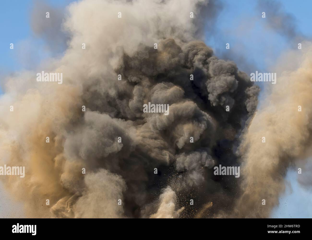 Dust and rock particles during powerful detonator blast Stock Photo - Alamy