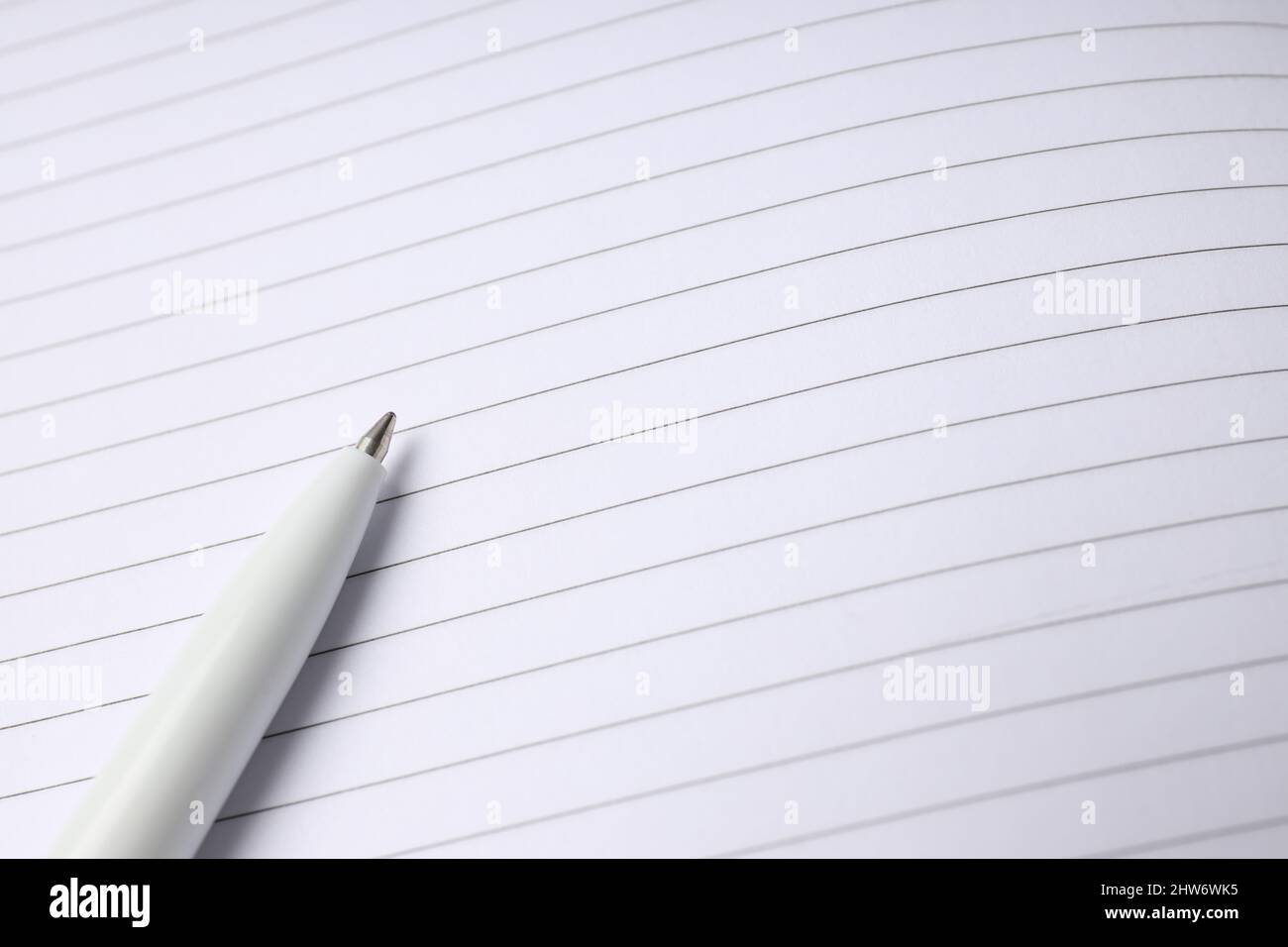 Blank notebook with pen on whole background Stock Photo - Alamy