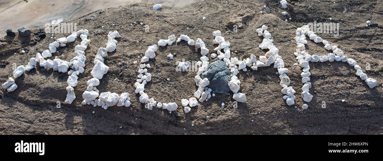 ALOHA rock spelling in nature with white stones on the rocky beach of ...