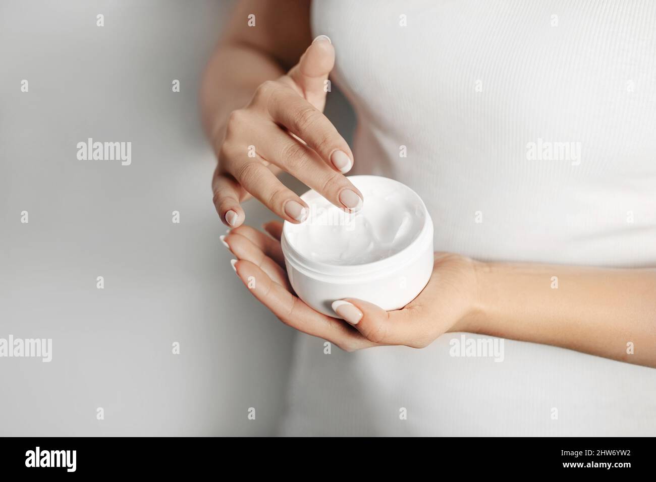 Closeup of female hands applying hand cream, lotion. Hand skin care ...