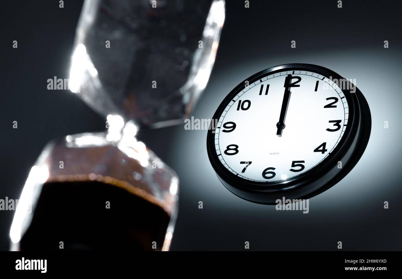 The Wall Clock and the hourglass colored Stock Photo - Alamy