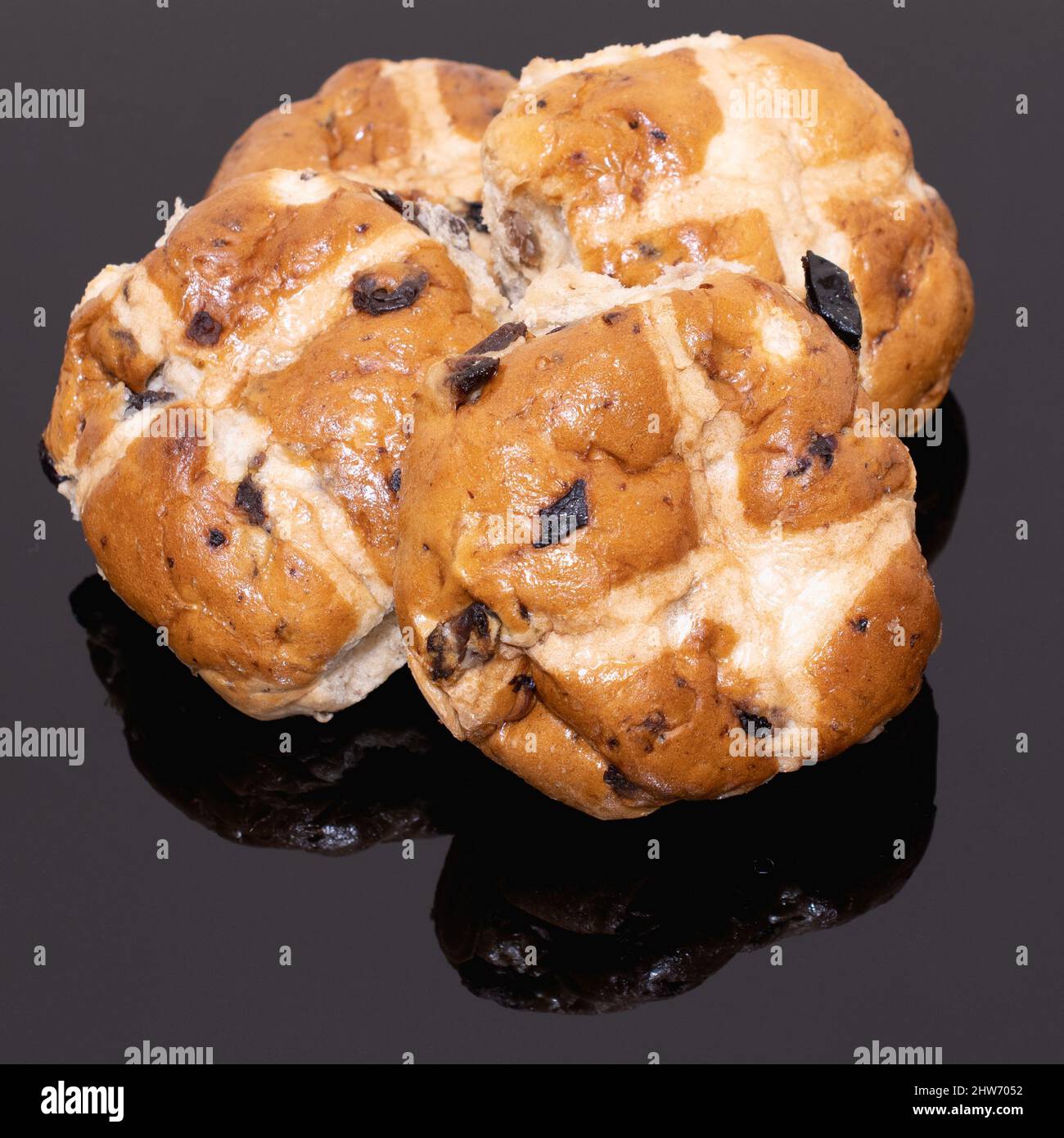 Top view hot cross buns on dark background. Sweet bun marked with a ...