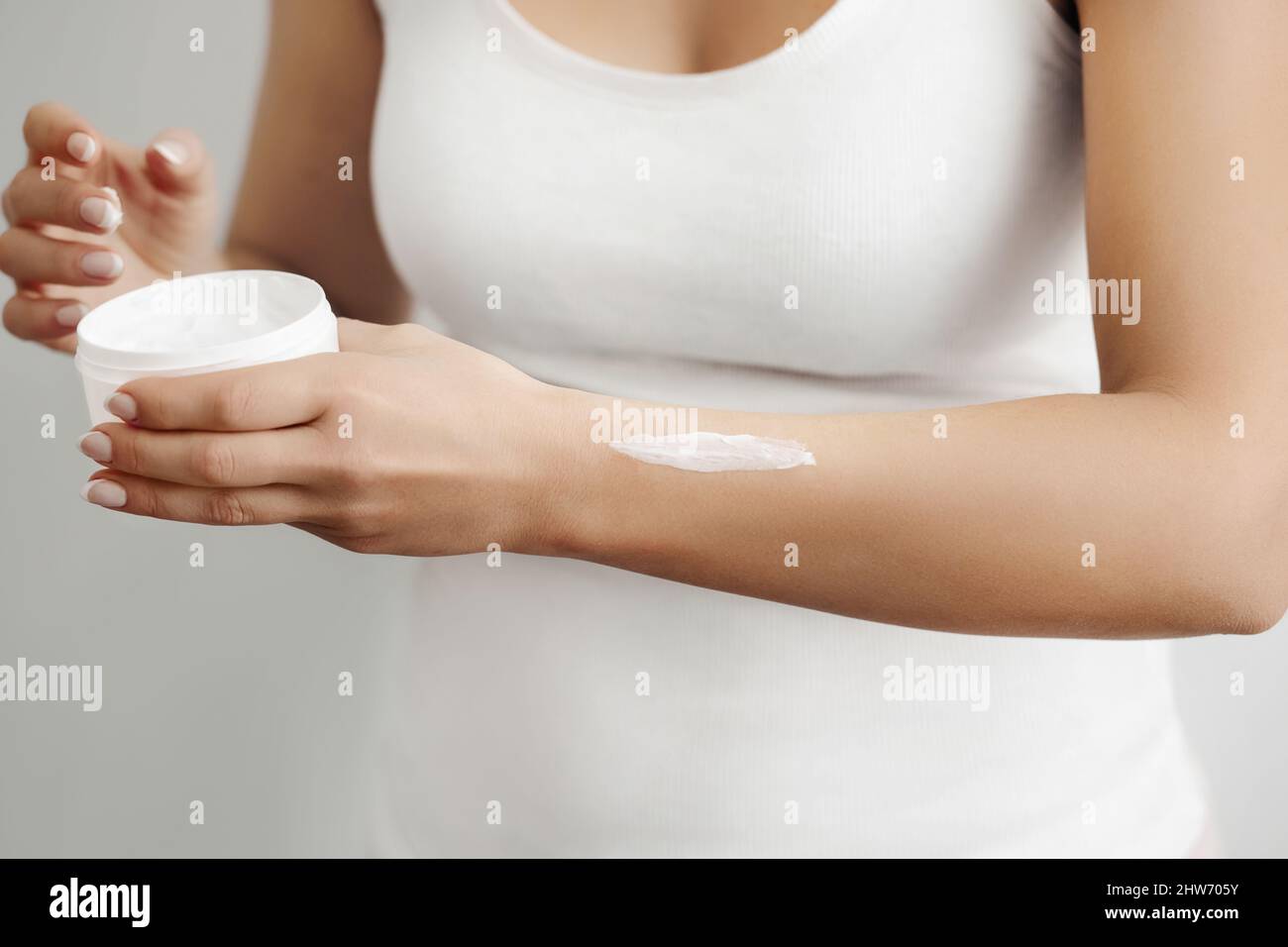 Woman hands applying moisturizing cream to her skin. Spa and Manicure ...