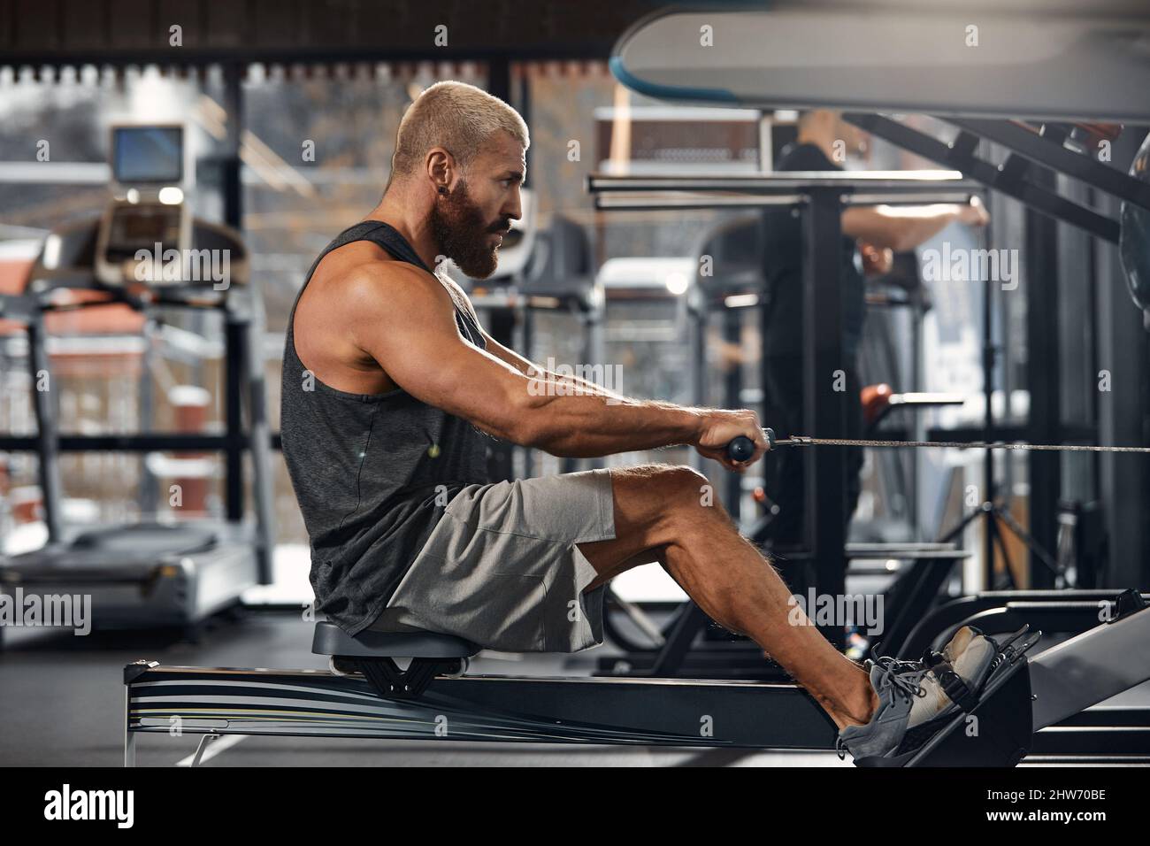 Training legs in the simulator, the athlete works with his legs on the ...