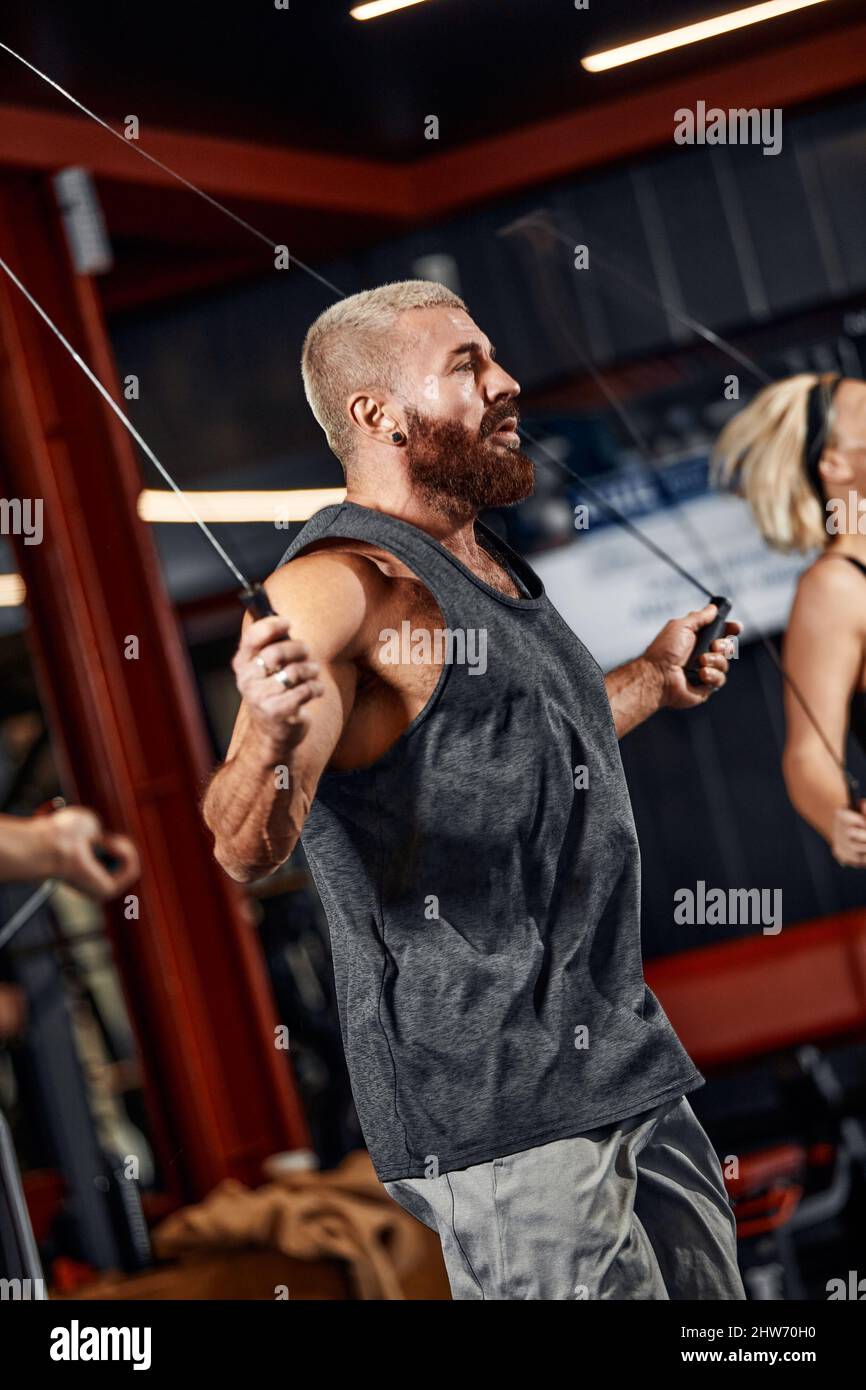 Group of athletic people using jump ropes for their workout in a cross ...
