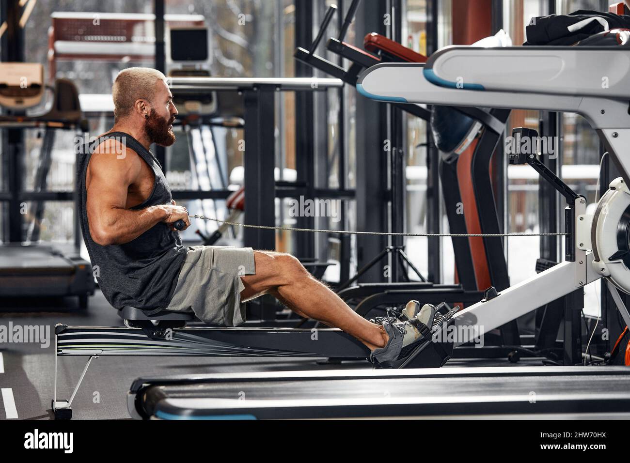 Training legs in the simulator, the athlete works with his legs on the ...