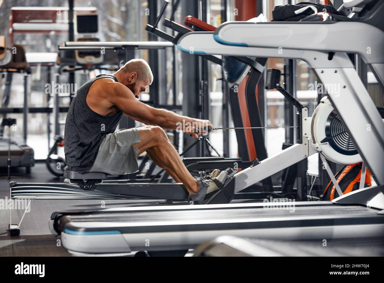 Training legs in the simulator, the athlete works with his legs on the ...