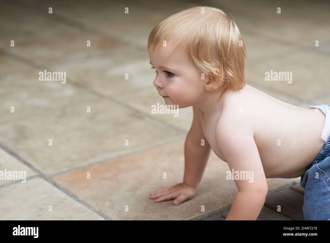 Crawling around the house. A sweet little baby boy crawling outside ...