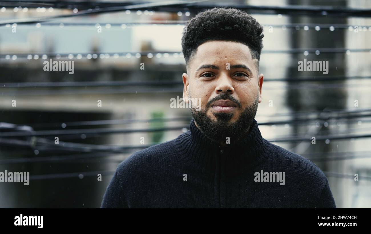 A young diverse man standing in urban street portrait face Stock Photo ...