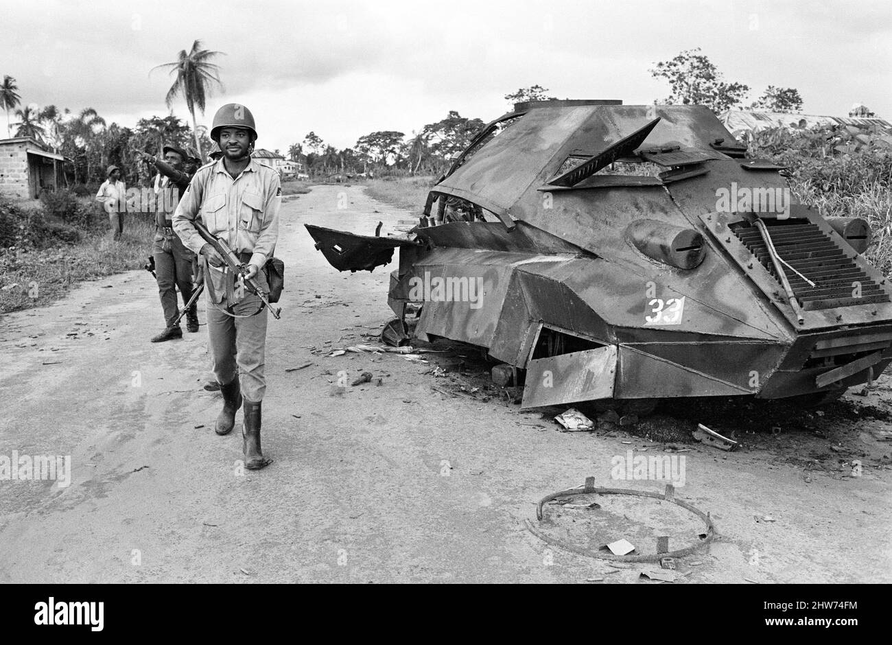 A Biafran soldier seen here beside a destroyed Nigerian army armoured personnel carrier during ...