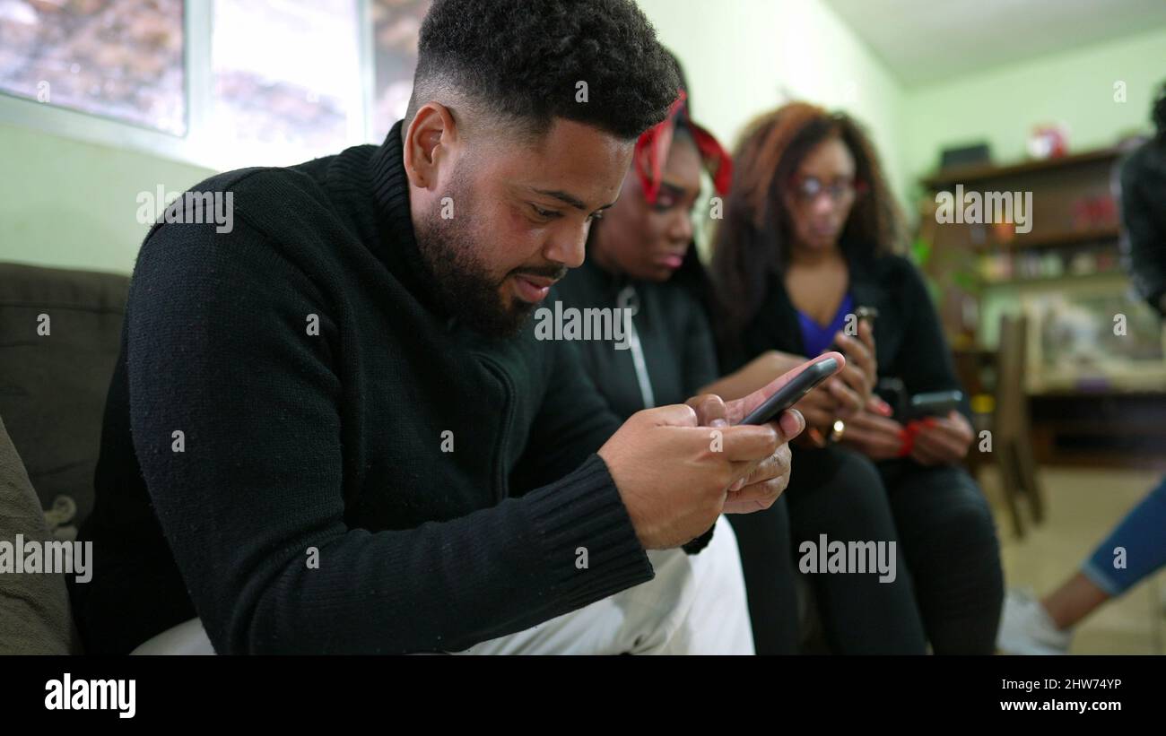 People hanging out staring at phones each person in their own ...