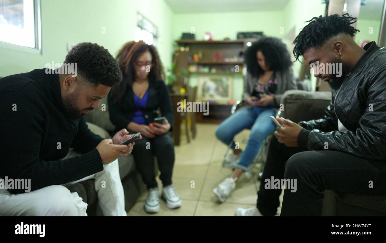 People hanging out staring at phones each person in their own ...