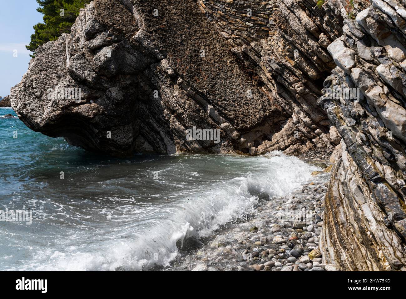 Waves splashing at rocks at the beach Stock Photo - Alamy
