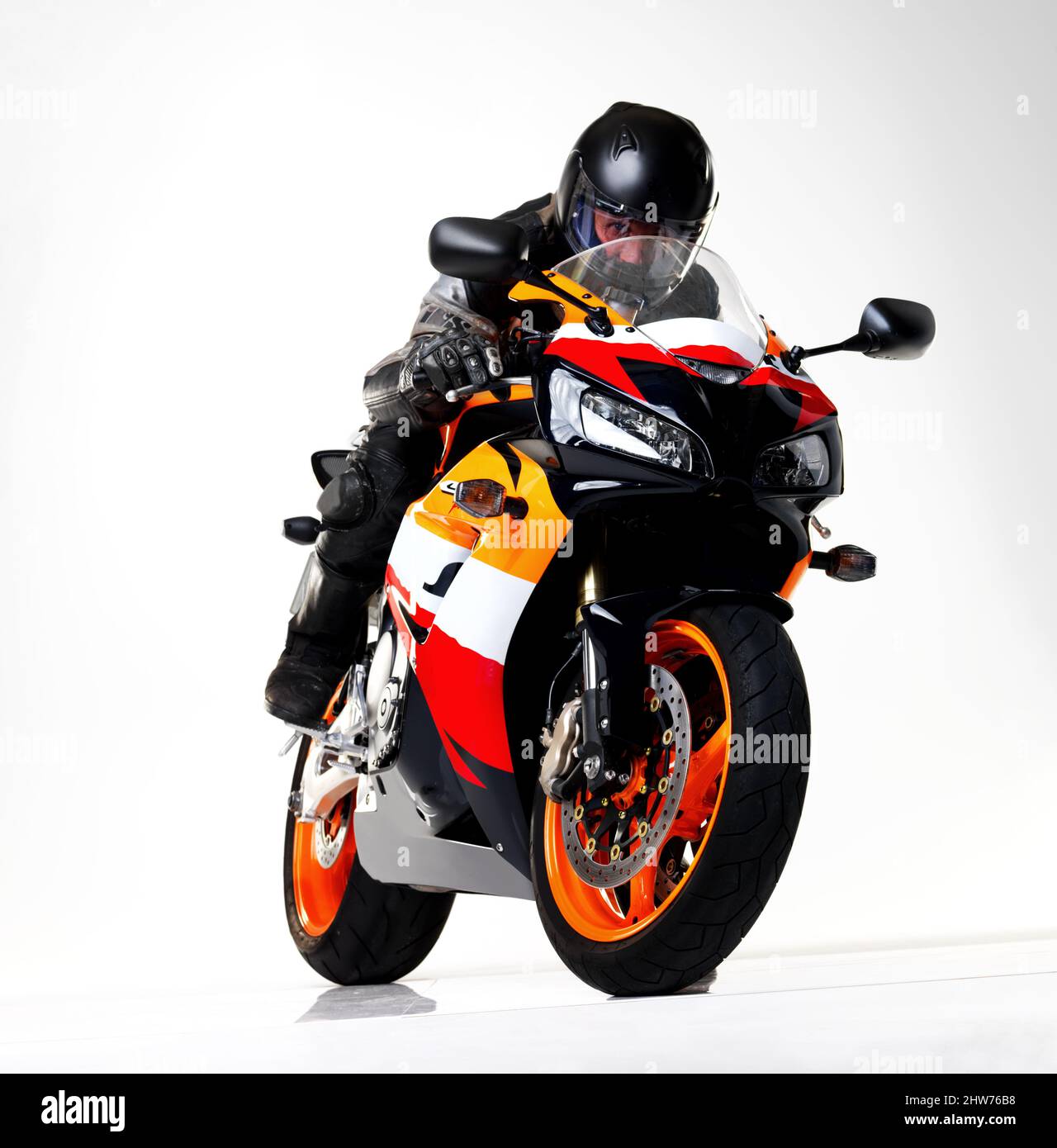 Daredevil. Full length studio shot of a biker racing a superbike Stock ...