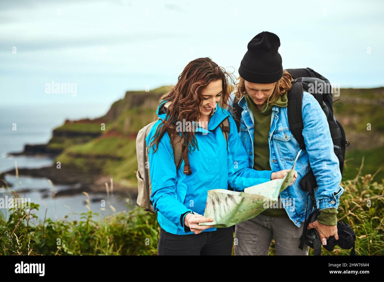 We will find our way together. Shot of a young couple looking at a map ...