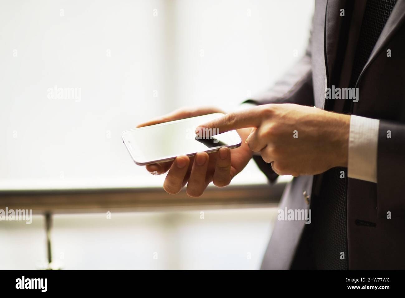 Close up of a man using mobile smart phone outdoor Stock Photo - Alamy
