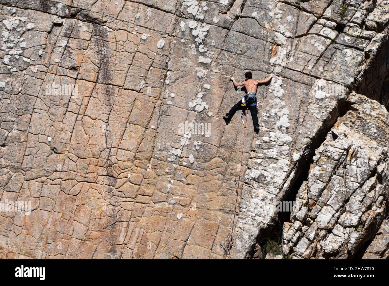 Single male person solo climber climbing a vertical pitch route in Zona ...