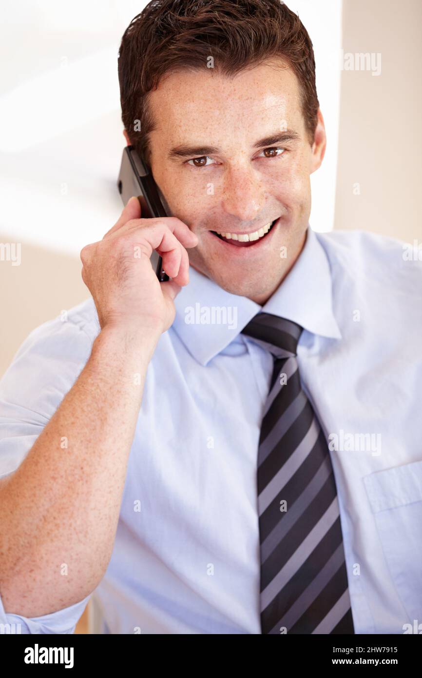 Lets set up a meeting.... Young business taking a business call with a ...