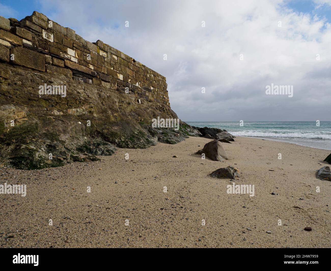 The remains of the pier wall part of the entrance to the harbour ...