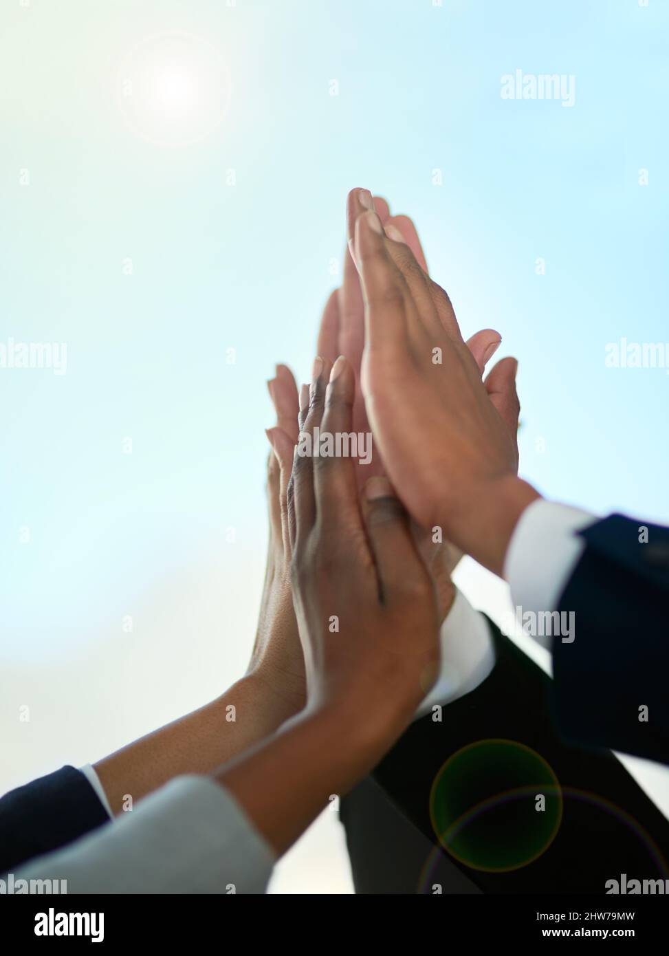 Go team. Cropped shot of a group of businesspeople giving each other a ...