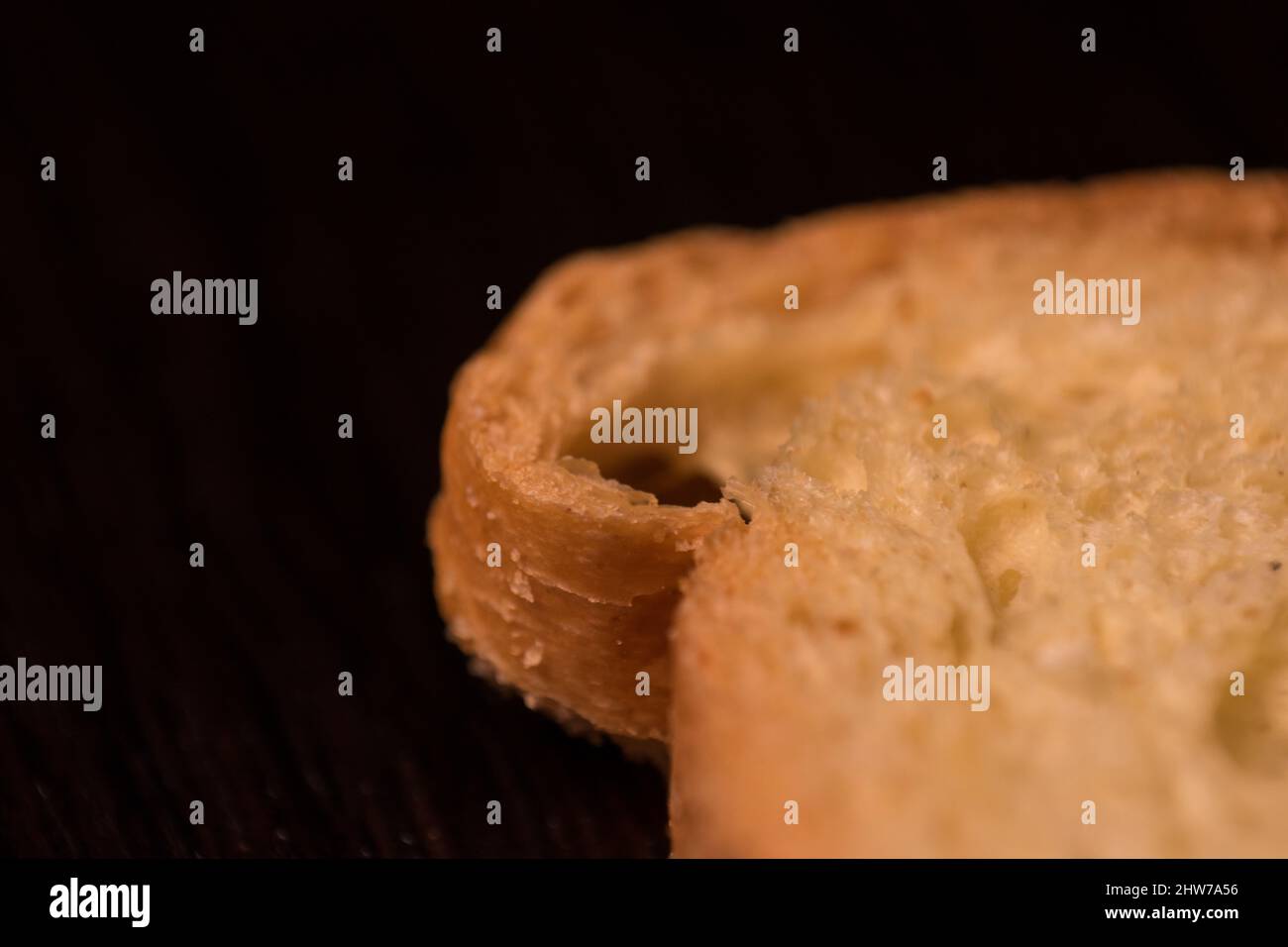 Closeup shot of a piece of toast on a wooden table Stock Photo - Alamy