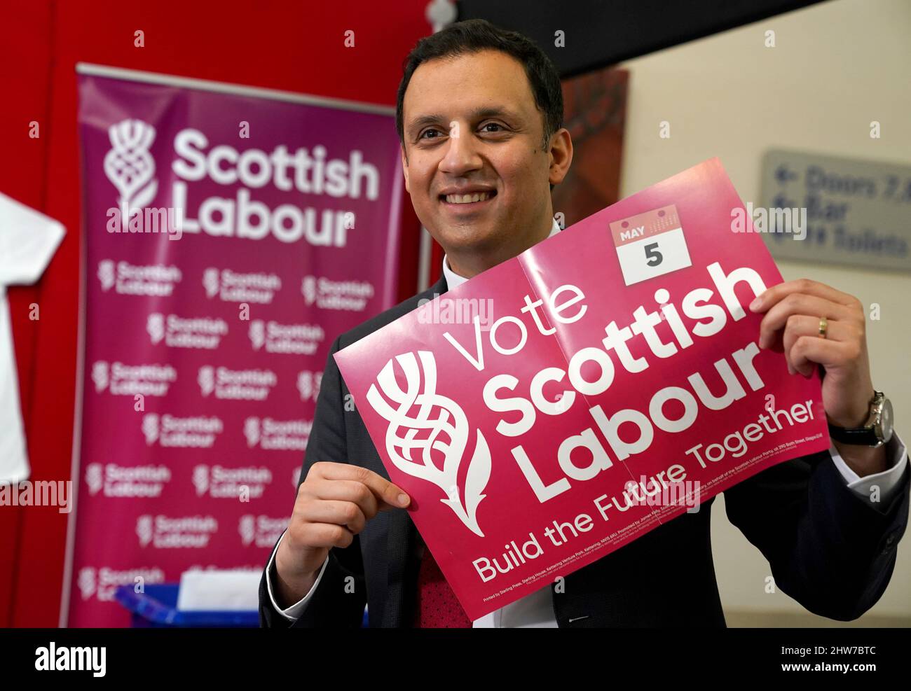 Scottish Labour leader Anas Sarwar holds a poster showing the new ...