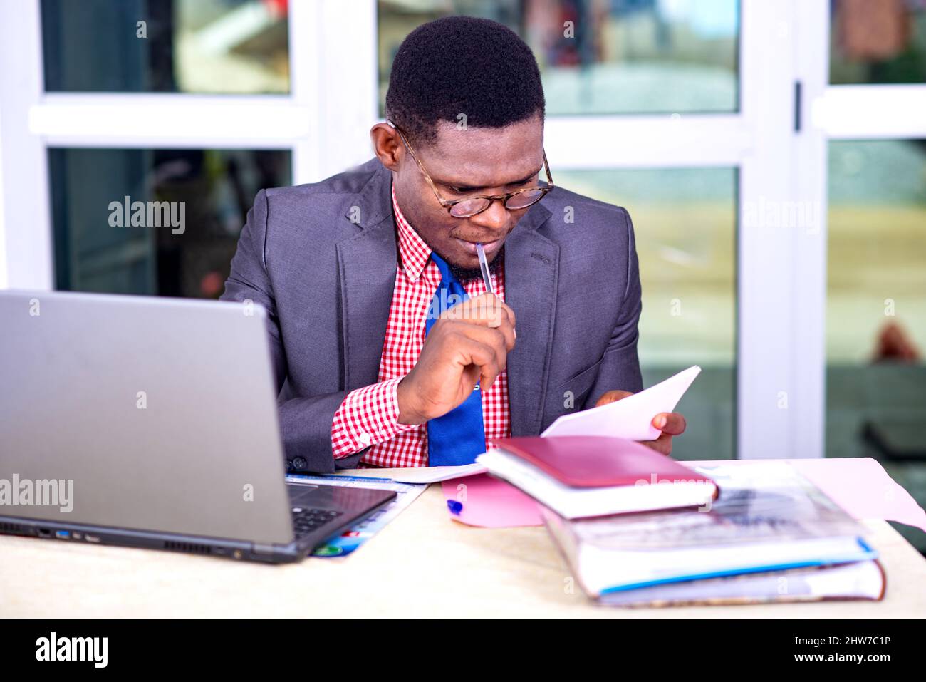 Serious adult businessman sitting in front of laptop thinking about ...