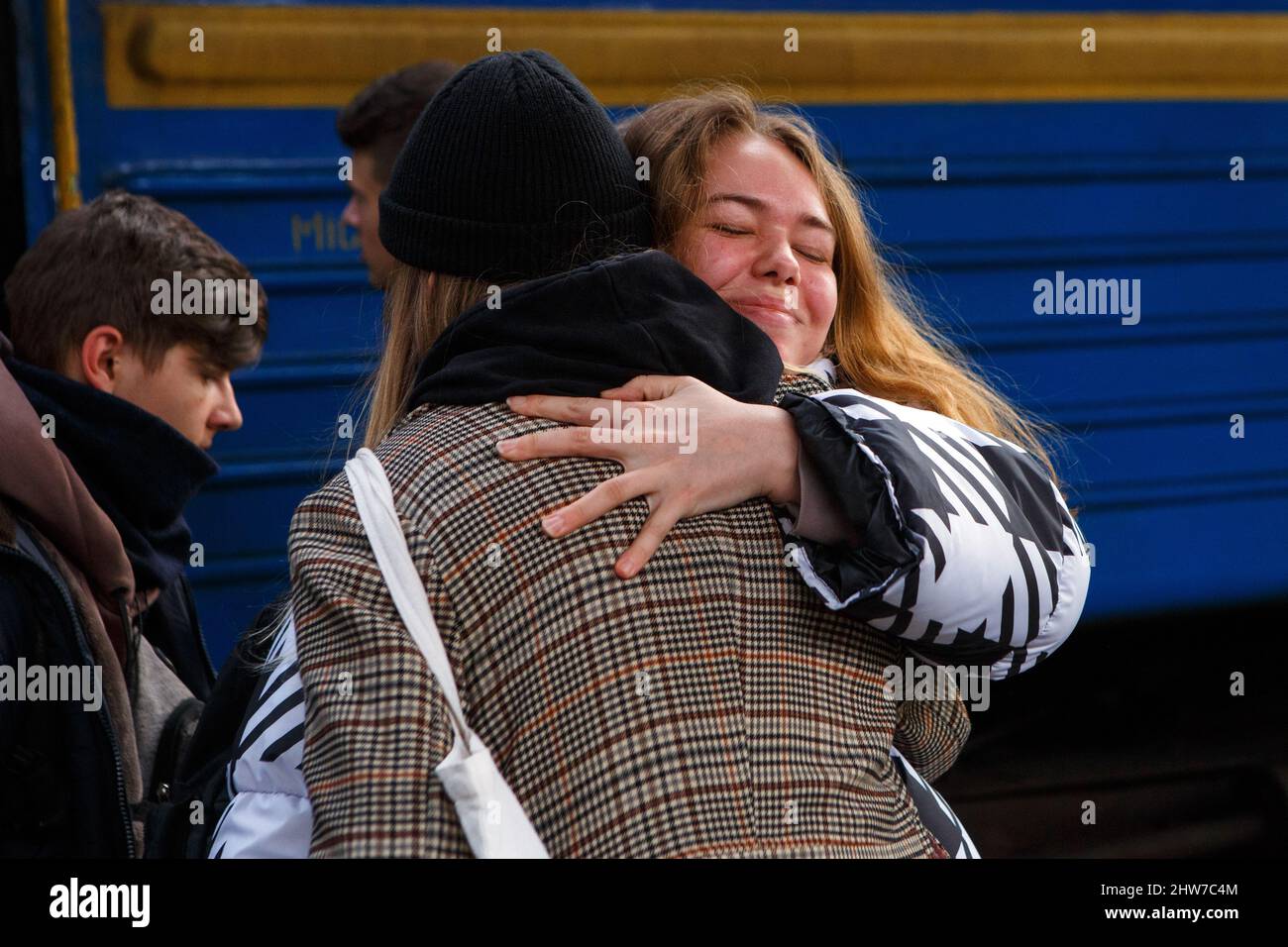Women hug by the train evacuating the refugees who fled from Ukrainian ...