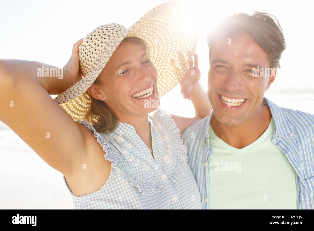 Bliss in the sun. A happy couple laughing together on the beach Stock ...