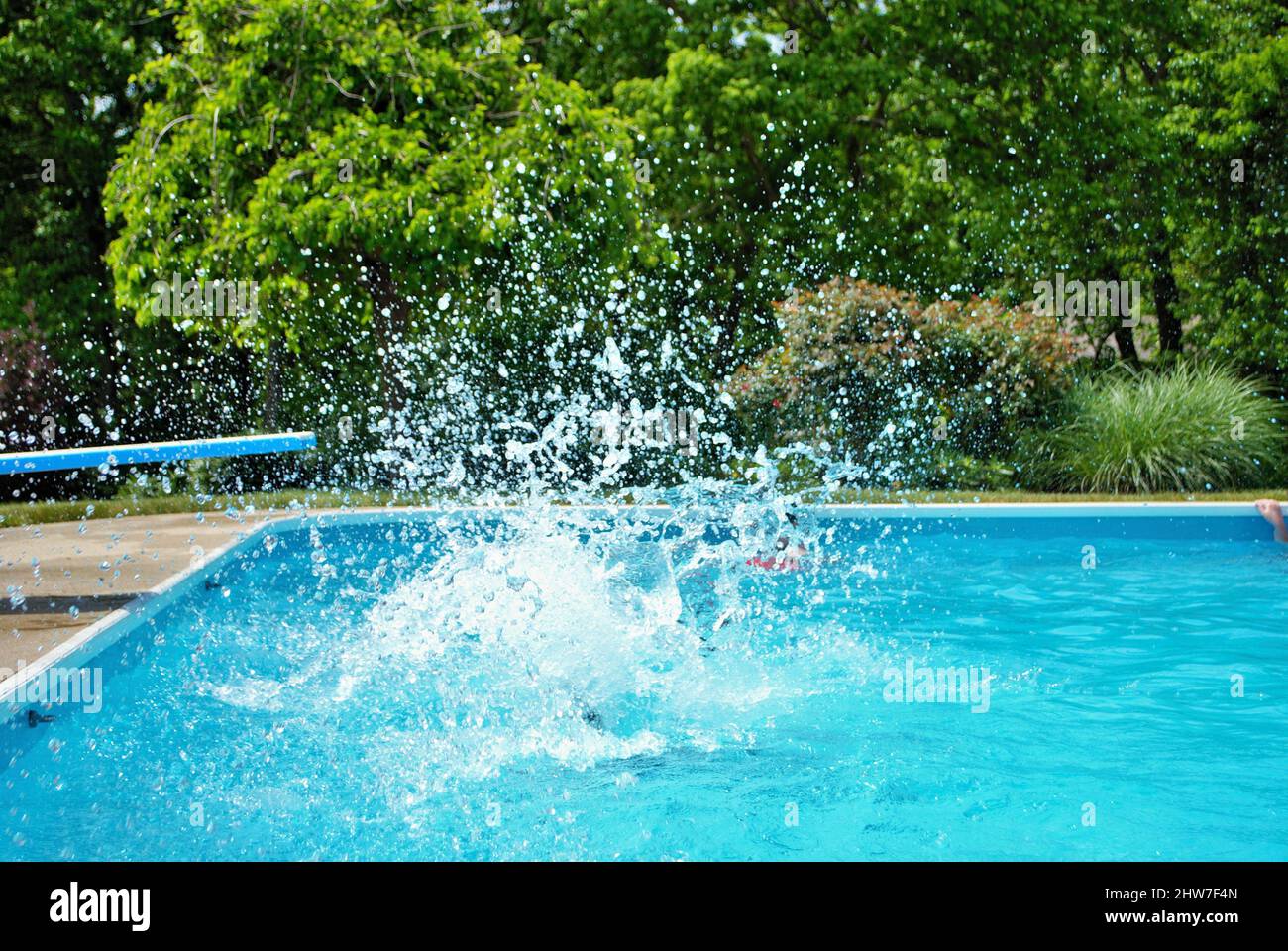 Big splash after someone jumped off the diving board Stock Photo - Alamy