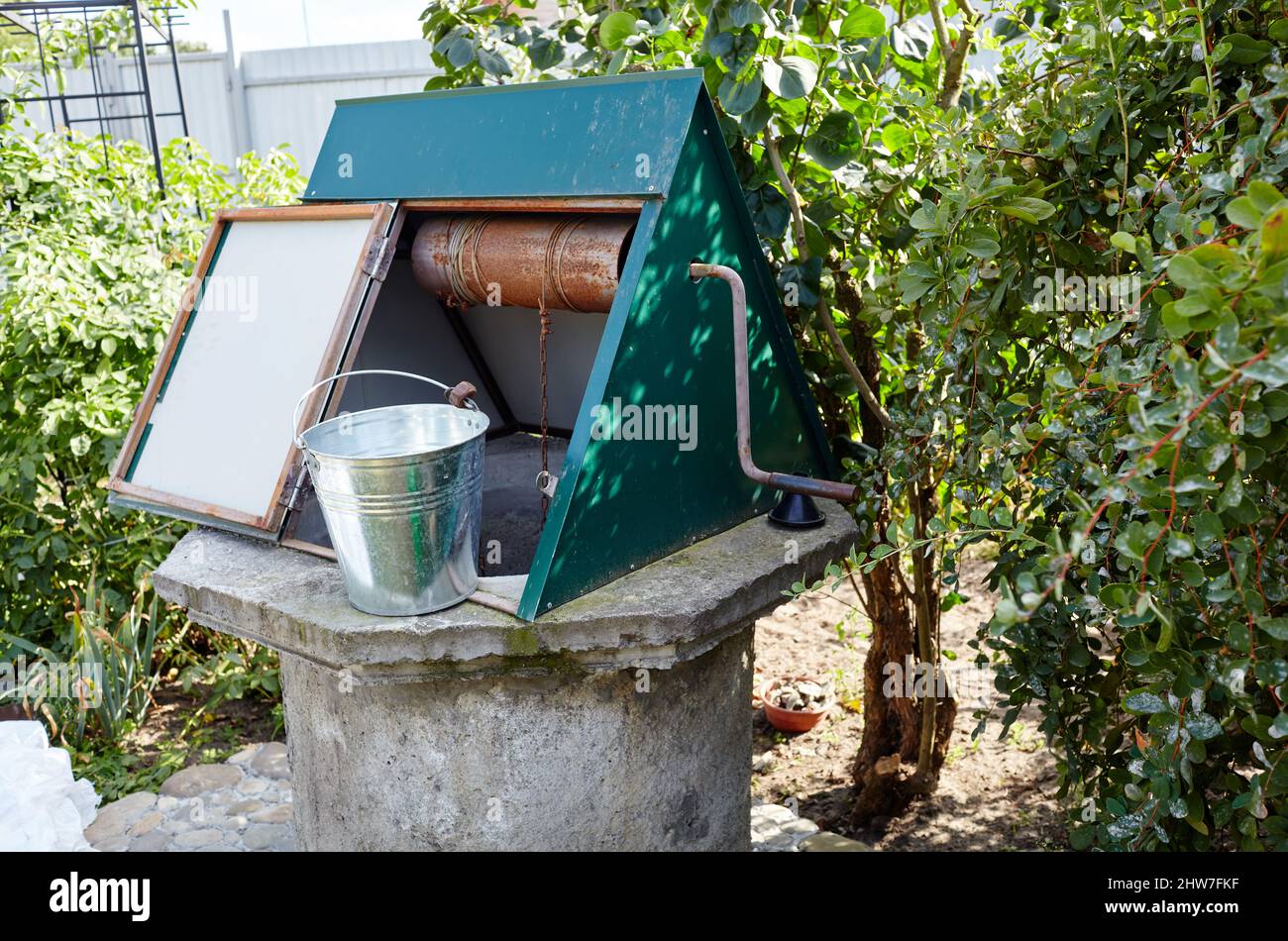 Old draw-well in European village. Retro stone water well in rural area ...