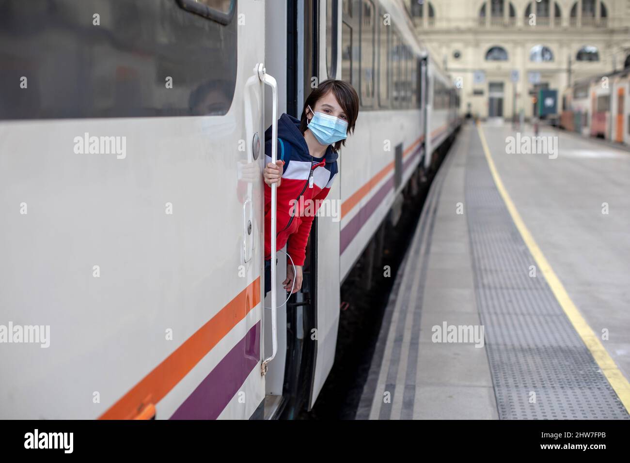 Cute little child tourists, standing on the stairs of a train in ...