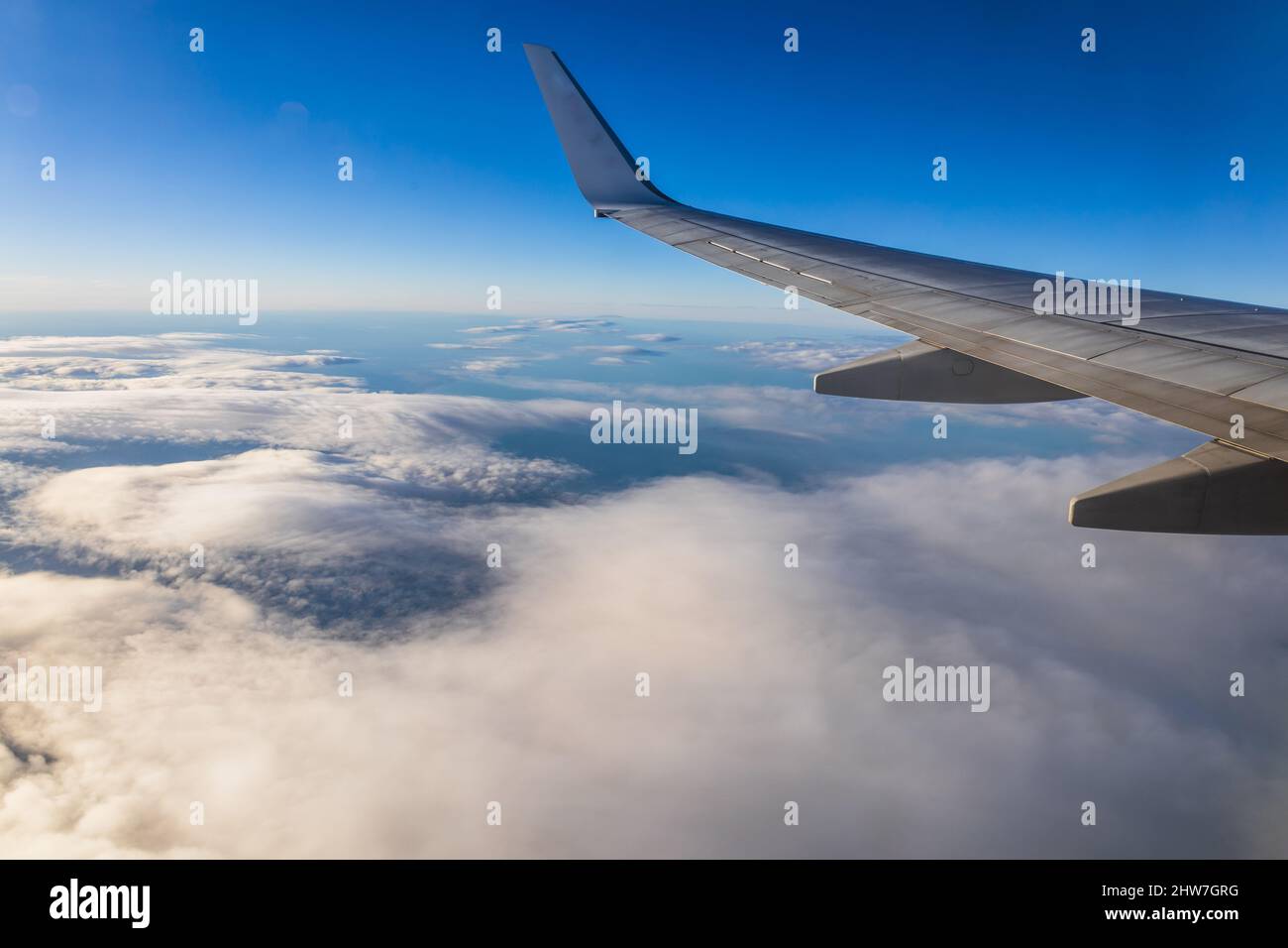 The view of the horizon line across the blue sky on the airplane during ...