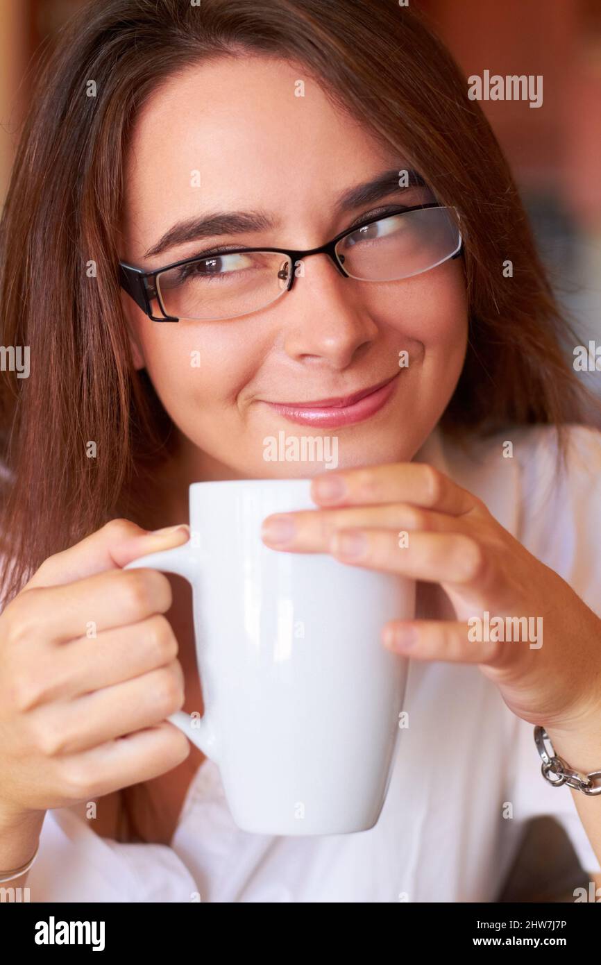 Excited for the day ahead. A young woman drinking her coffee with a ...