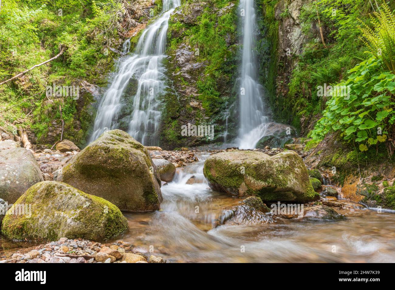 Beautiful fresh mountain waterfall in a wild and isolated valley in ...