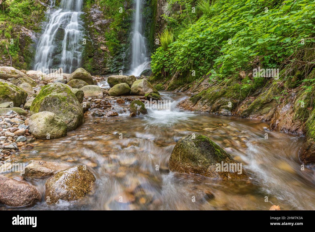 Beautiful fresh mountain waterfall in a wild and isolated valley in ...
