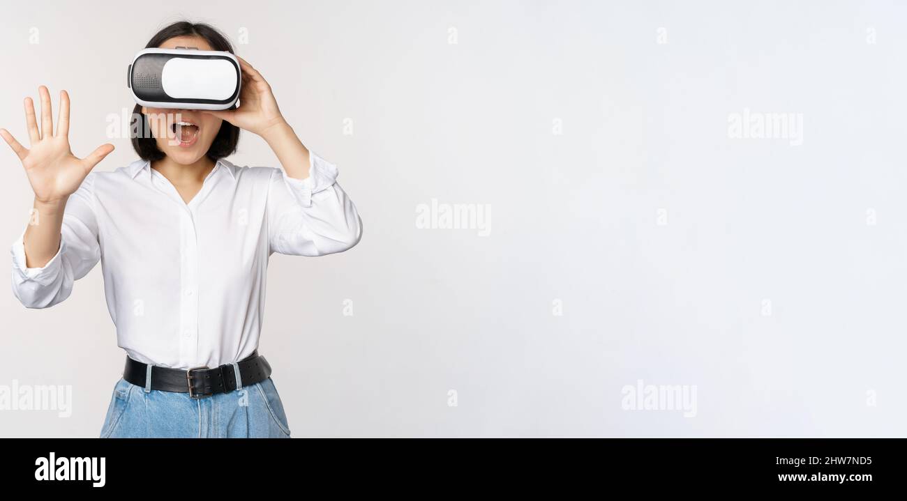 Vr chat. Asian girl saying hello in virtual reality glasses, smiling ...