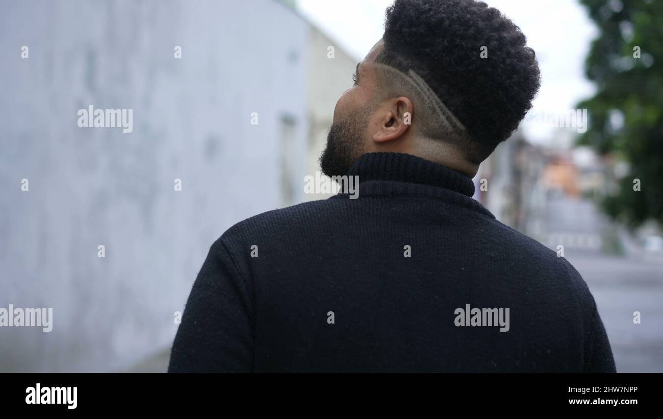 Man standing outside looking up to sky thoughtful person looks up Stock ...