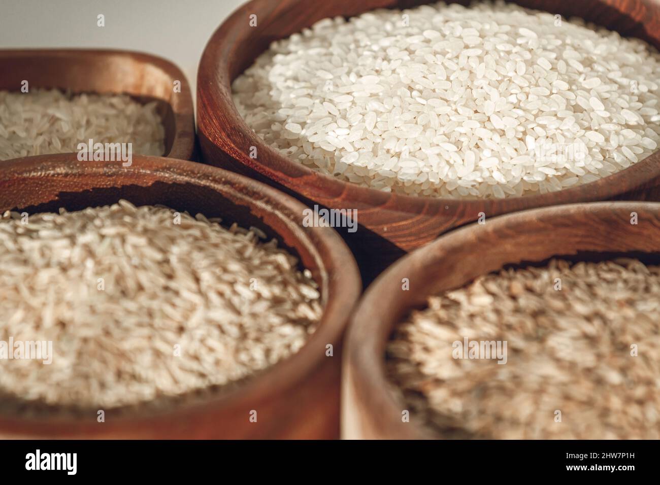 Set of different types of rice and cereals in wooden bowls Stock Photo ...