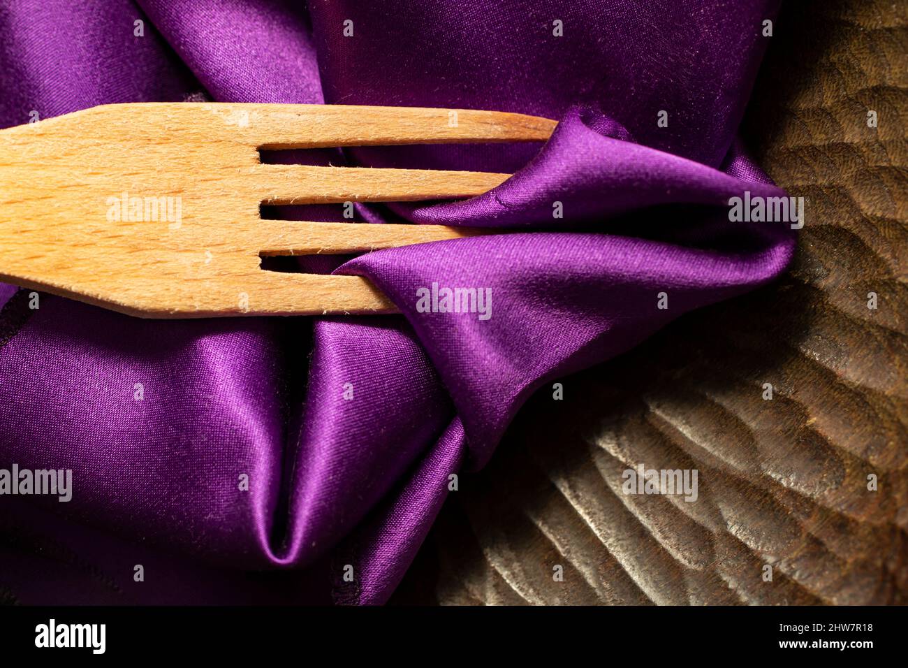 wooden fork and purple satin on a sculpted rustic plate Stock Photo - Alamy