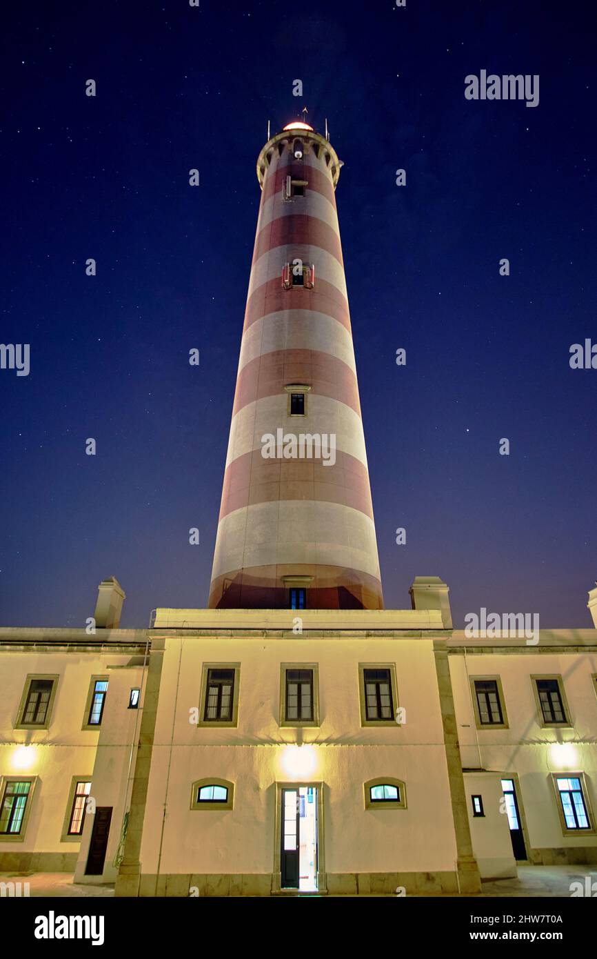 Low angle of the biggest lighthouse in Portugal against the blue starry ...