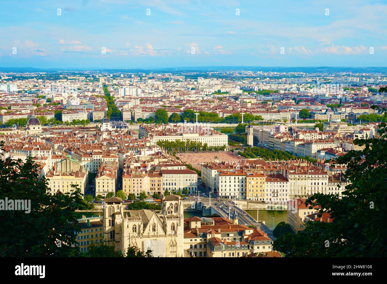 Lyon skyline during the end of summer with trees in the front, church ...