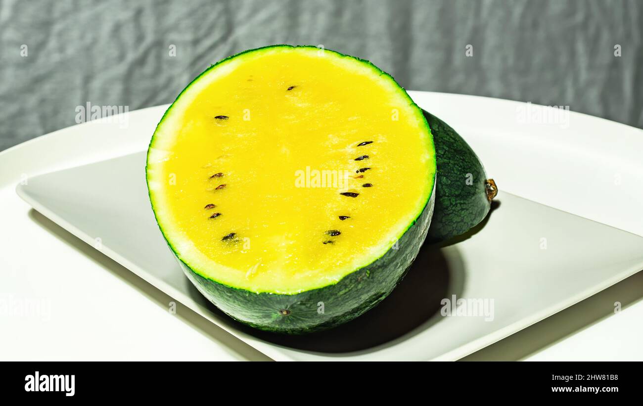 Small, fresh, bright watermelon of the Dragon's Egg variety yellow ...