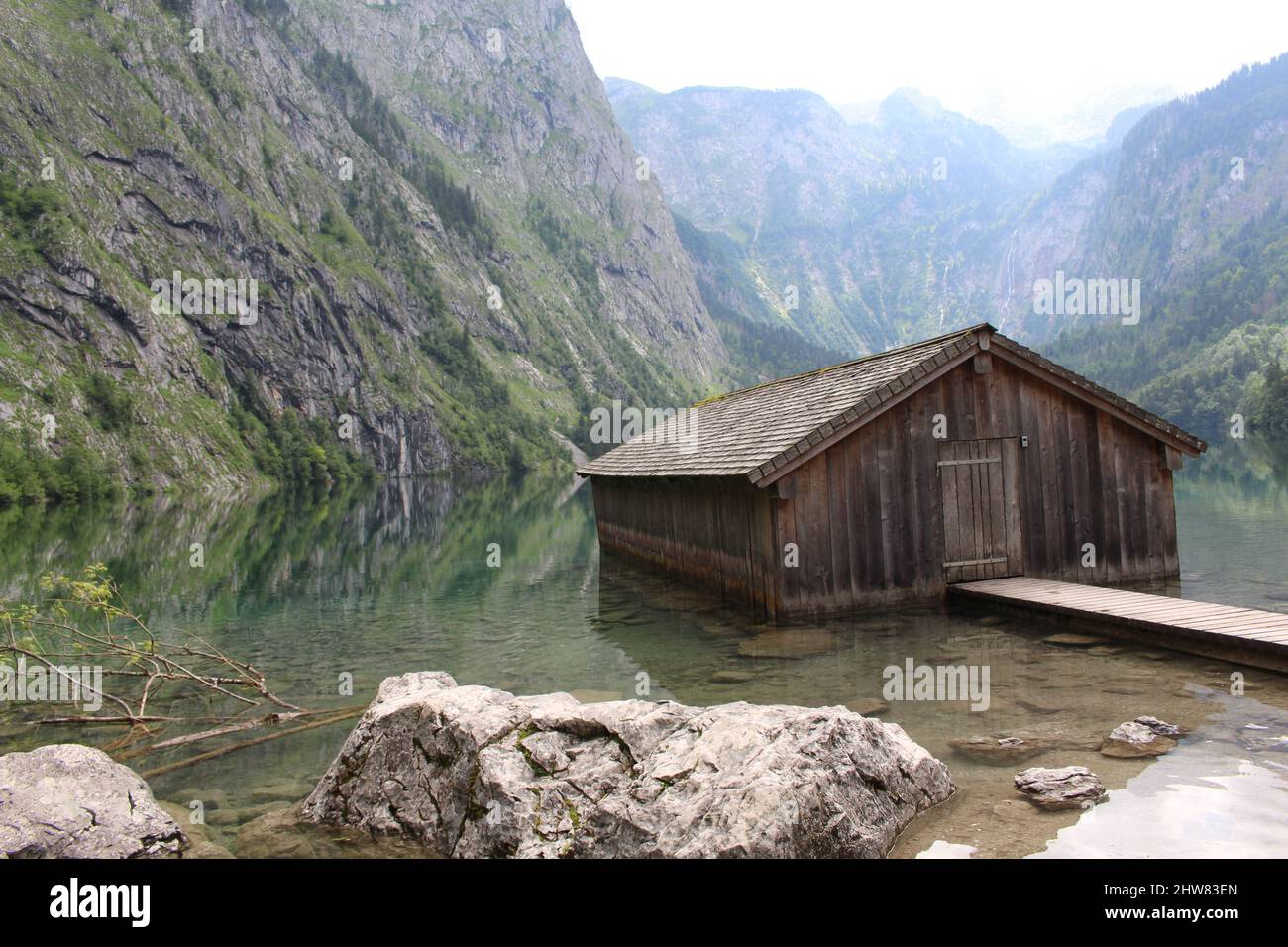 A small wooden Hut in water with mountain Stock Photo - Alamy
