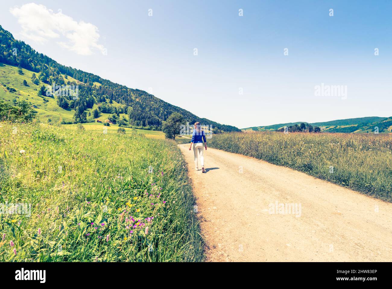 Woman walking in wildflowers hi-res stock photography and images - Alamy