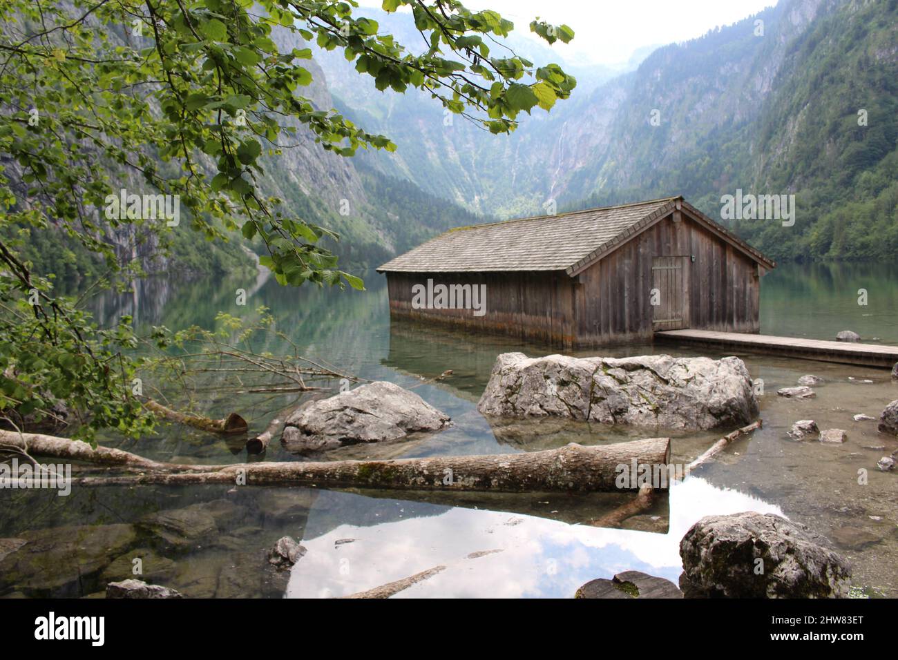 Small wooden Hut in water with mountain Stock Photo - Alamy