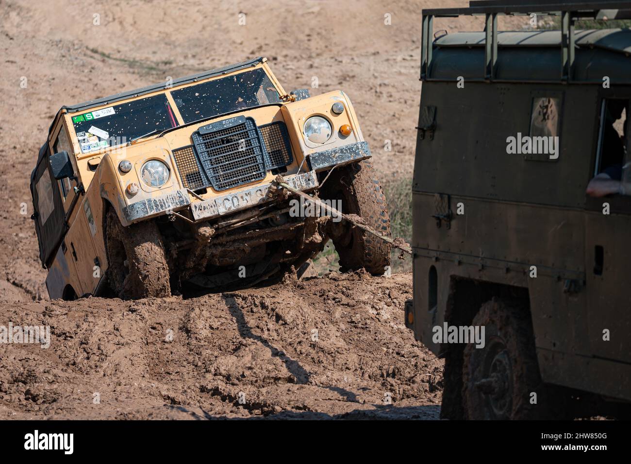 Photo of an old yellow Land Rover Santana Series three being towed with ...