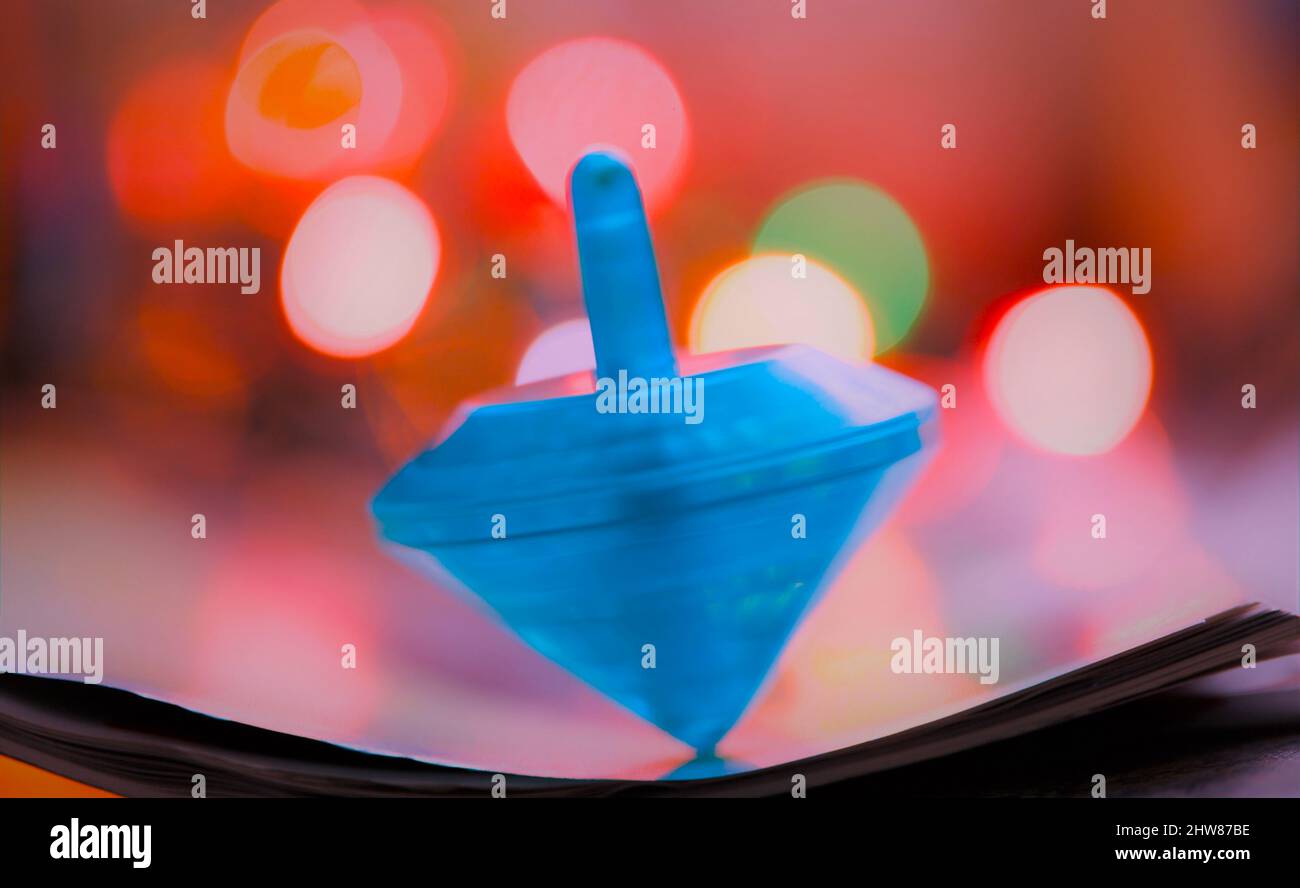 Defocused close-up of a blue spinning top in motion with bokeh Stock ...