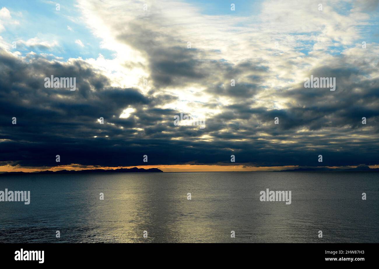 Sunset seen from Menorca, with the island of Mallroca on the horizon ...
